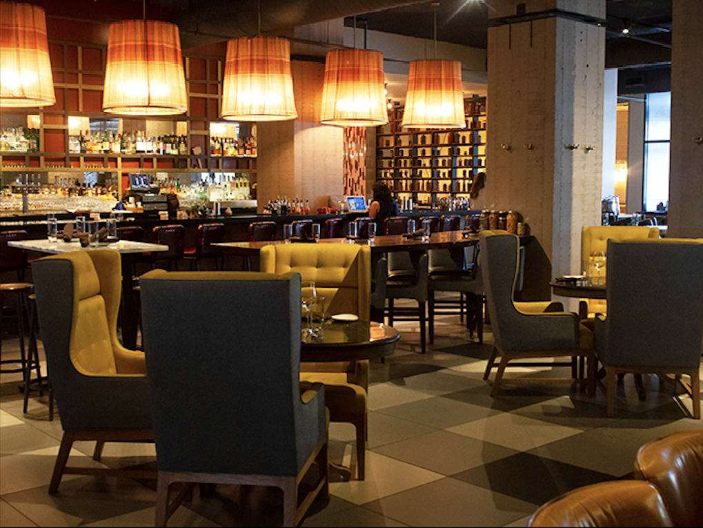 Step inside and discover a perfect marriage of contemporary design and classic steakhouse comfort—those mustard chairs aren't just stylish, they're beckoning you.