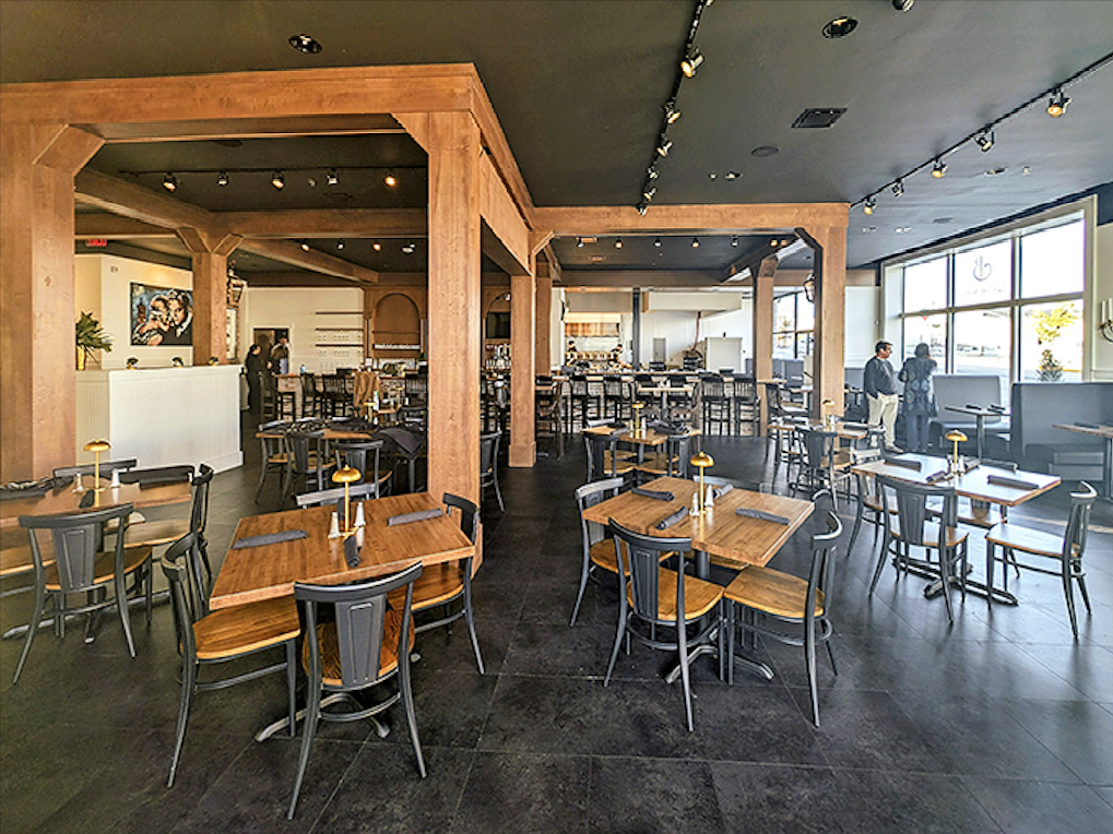 Modern meets classic in this thoughtfully designed dining room, where wooden beams frame spaces perfect for both intimate conversations and celebratory gatherings.