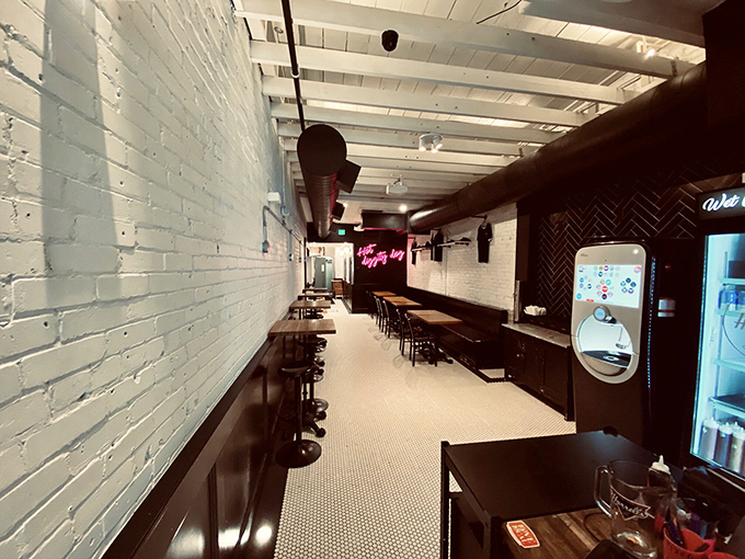 Minimalist cool meets comfort food at Harrell's interior. The pink neon "Hot diggity dog" sign isn't just decor—it's a prophecy of deliciousness to come.