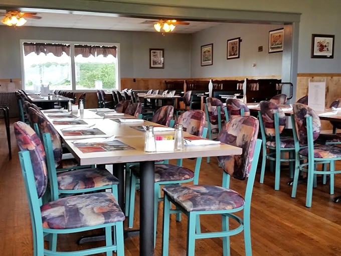 Step inside to a dining room where turquoise chairs pop against wooden accents—casual comfort that lets the food be the real showstopper.
