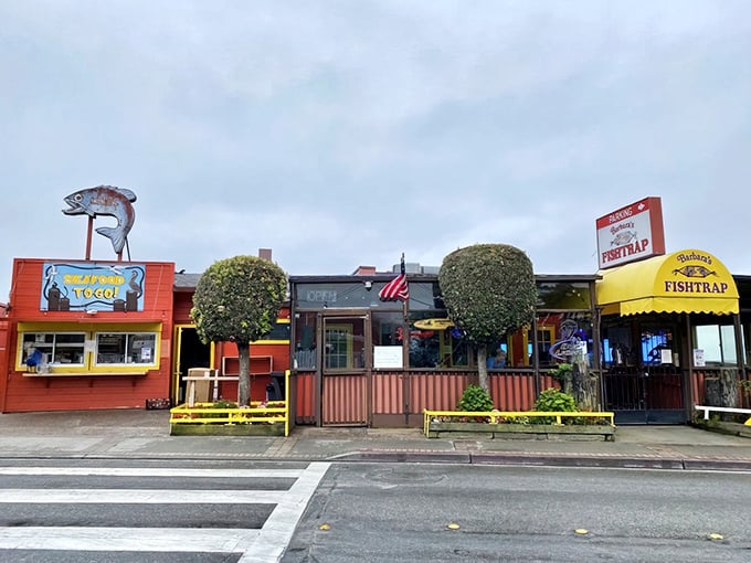 The bright yellow awning and weathered red exterior of Barbara's Fishtrap stands as a beacon for seafood lovers—no Instagram filters required for this authentic coastal gem.
