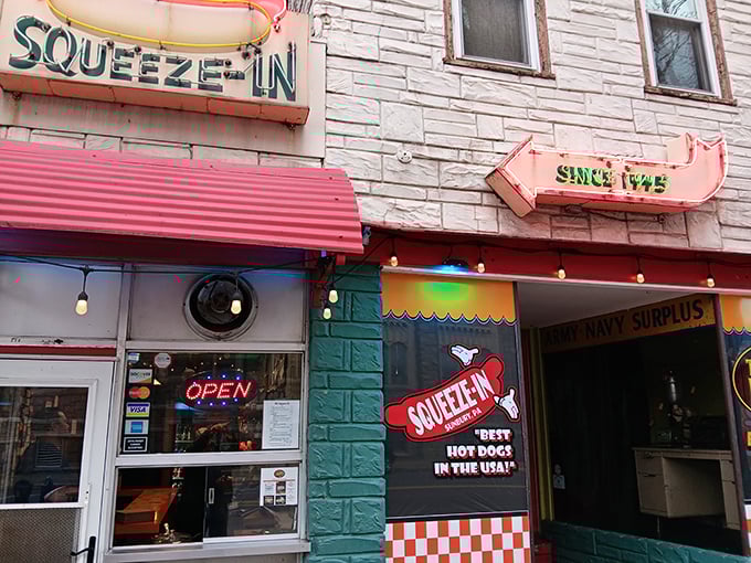 Not just a name – a literal instruction! The Squeeze-In's vintage storefront promises hot dog nirvana behind that unassuming facade.