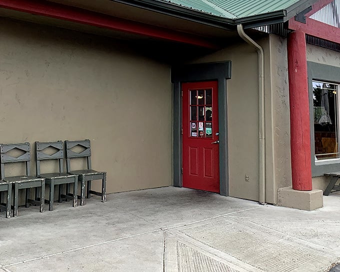 That red door isn't just an entrance—it's a portal to comfort food nirvana. The chairs outside suggest a place worth waiting for.