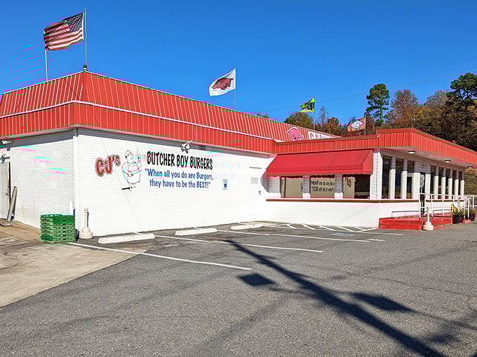 Flags flutter proudly above this temple of beef, where the motto "When all you do are Burgers, they have to be the BEST!" isn't just words—it's a mission statement.