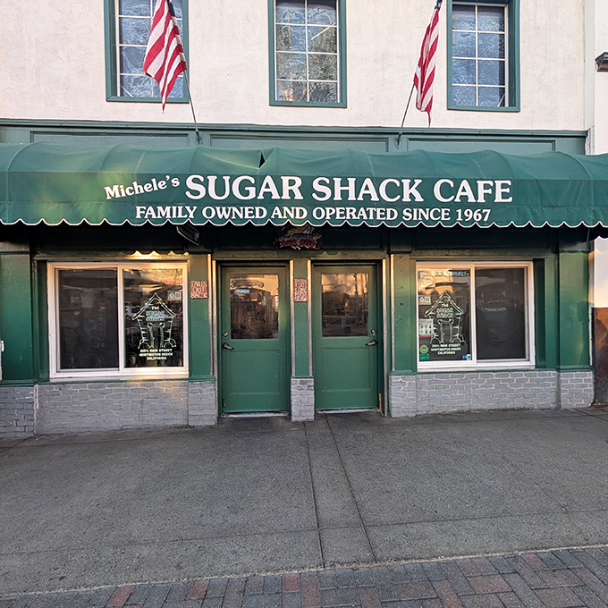 American flags proudly flank the entrance, announcing this isn't just a cafe—it's a local institution where beach town traditions are served daily alongside the coffee.
