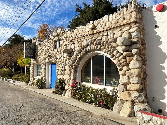 This stone façade isn't just a restaurant entrance—it's a portal to Provence hiding in plain sight along Sierra Highway.