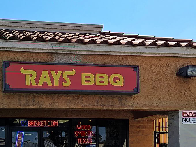 That iconic red and yellow sign beckons like a smoke signal to barbecue pilgrims. The neon promises aren't just marketing—they're a binding contract with your taste buds.