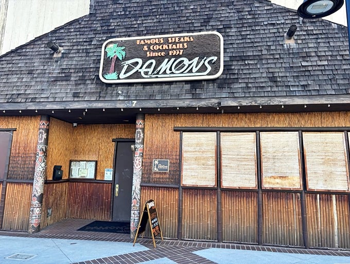 The iconic A-frame entrance to Damon's stands like a tiki time machine on Brand Boulevard, promising tropical escapism and serious steaks inside.