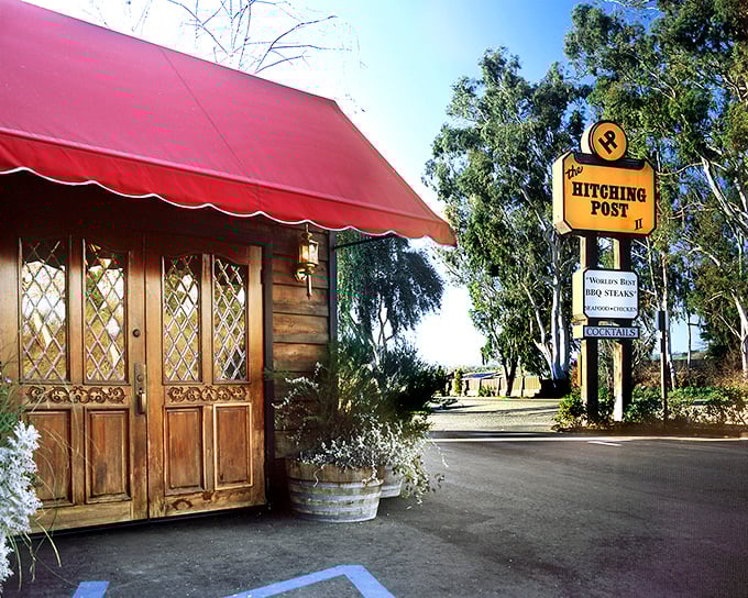 The iconic red awning and rustic wooden entrance of The Hitching Post II welcomes you like an old friend who happens to make the best steaks in California.