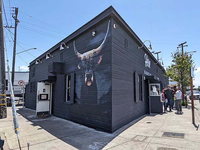 The matte black exterior with that magnificent longhorn mural isn't just a building—it's a smoke signal to barbecue pilgrims that they've reached the promised land.