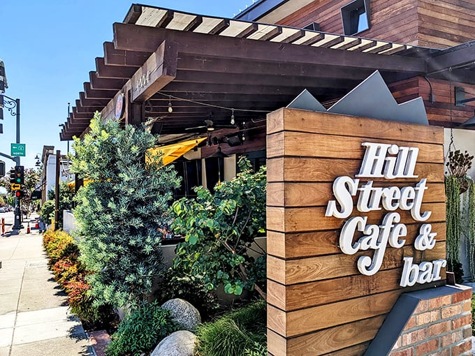 The welcoming wooden facade of Hill Street Cafe & Bar beckons with its stylish signage and lush greenery – California casual dining at its finest.