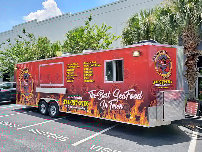 The fiery red Seafood Bandits truck beckons hungry visitors with its bold promise of "The Best Seafood In Town." Judging by the line forming, they might be right!