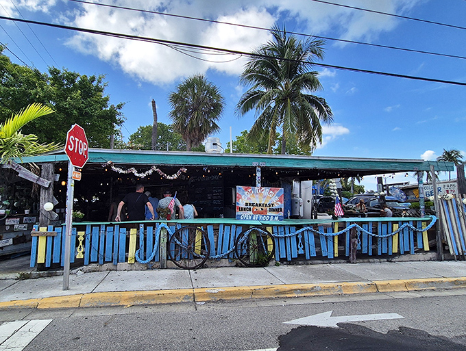 The blue and white striped entrance beckons like a siren song for seafood lovers seeking authentic Key West flavors.