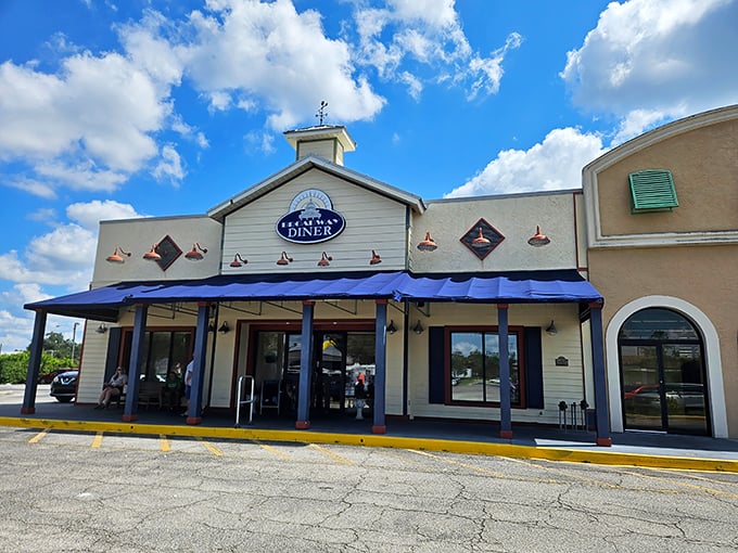 Not all heroes wear capes – some wear blue awnings. Broadway Diner's charming exterior promises comfort food salvation for hungry travelers crossing Polk County.
