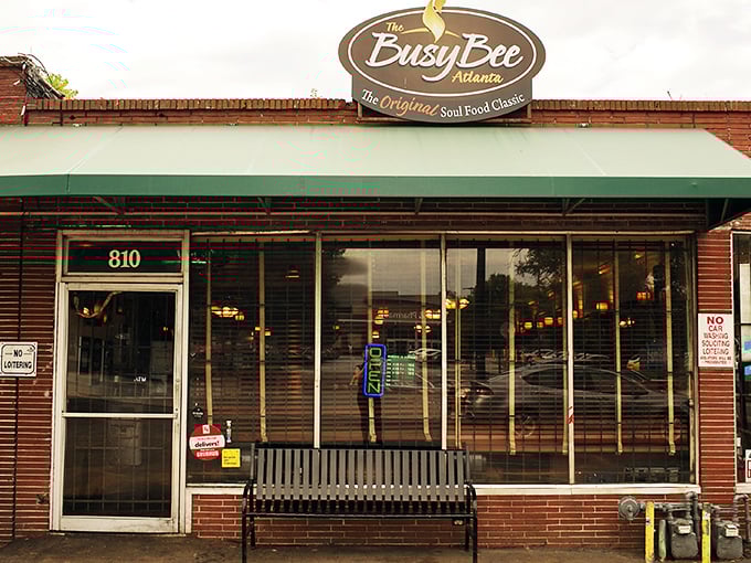 The unassuming brick exterior of Busy Bee Café hides Atlanta's soul food treasure. That bench outside has witnessed countless hungry patrons waiting their turn for greatness.