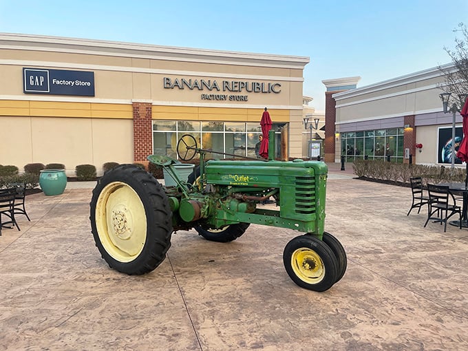 A vintage John Deere tractor parked outside Gap and Banana Republic – where farm charm meets fashion in a uniquely Georgian retail mashup.