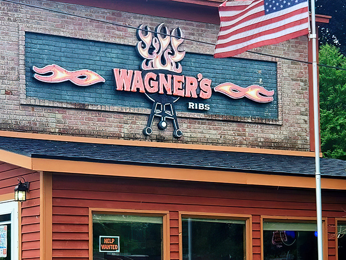 The iconic Wagner's Ribs sign stands as a beacon of barbecue hope, complete with flames and crossed utensils – the universal symbol for "prepare your taste buds for glory."