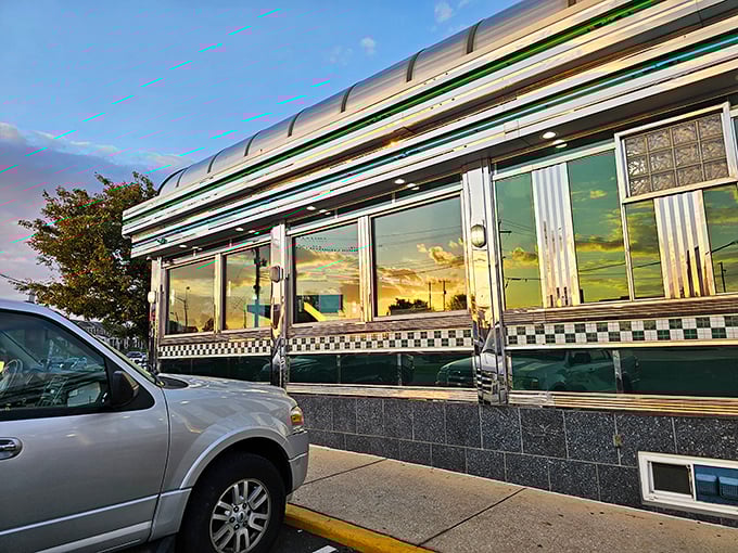 The gleaming stainless steel exterior of Broadway Diner catches the sunset, promising comfort food and nostalgia inside this Baltimore institution.