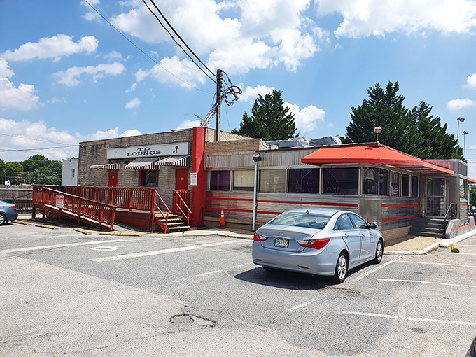 The classic red steps and striped awning aren't just an entrance—they're a time portal to when diners ruled American highways. 