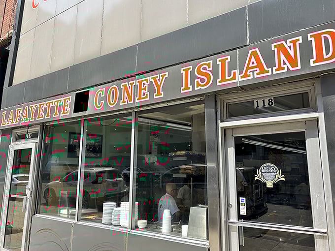 A glimpse through the windows reveals the temple of taste where Detroit's most famous hot dogs are assembled with military precision and decades of know-how.