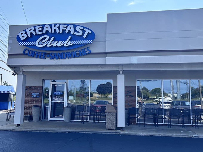 The blue and white façade of Breakfast Club stands like a beacon of morning hope on Grand River Avenue, promising coffee salvation to the breakfast-deprived masses.
