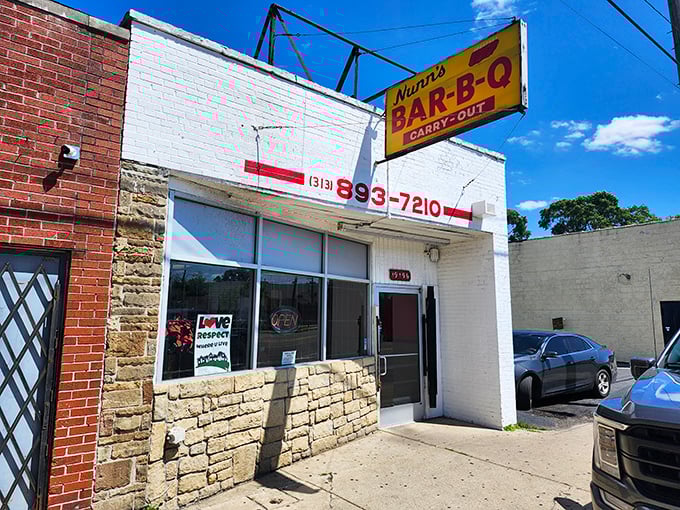Bright yellow signage announces this carry-out barbecue haven to the world—no fancy frills needed when the food speaks this loudly.