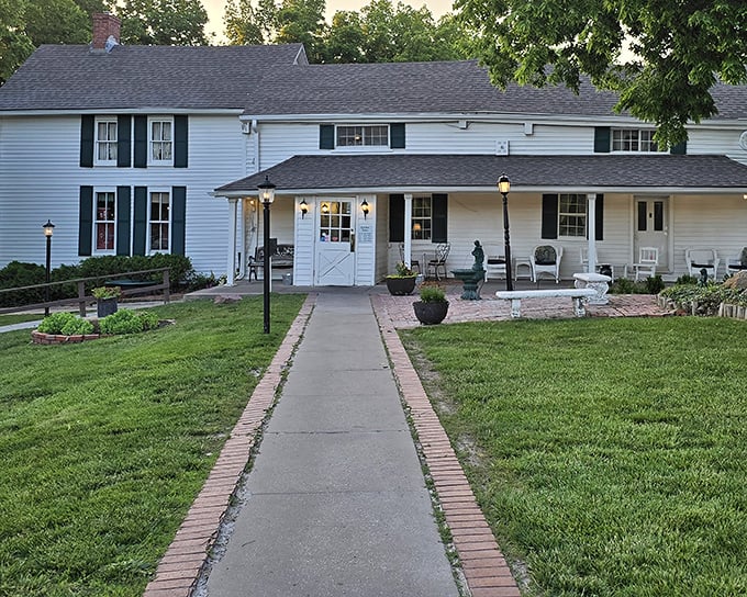 The white farmhouse exterior of Stroud's Oak Ridge Manor beckons like an old friend, promising comfort food and zero pretension.