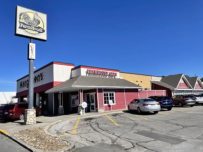 The red-sided FarmHouse Cafe stands like a beacon of breakfast hope against the Nebraska sky, promising cinnamon-scented salvation to hungry travelers.