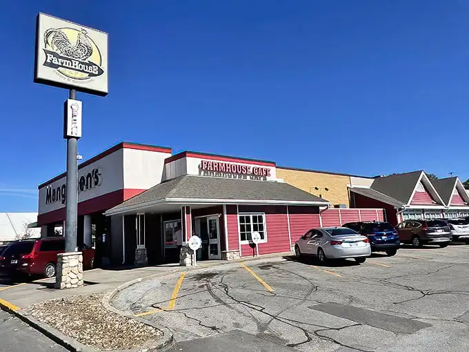 The red-sided FarmHouse Cafe stands like a beacon of breakfast hope against the Nebraska sky, promising cinnamon-scented salvation to hungry travelers.