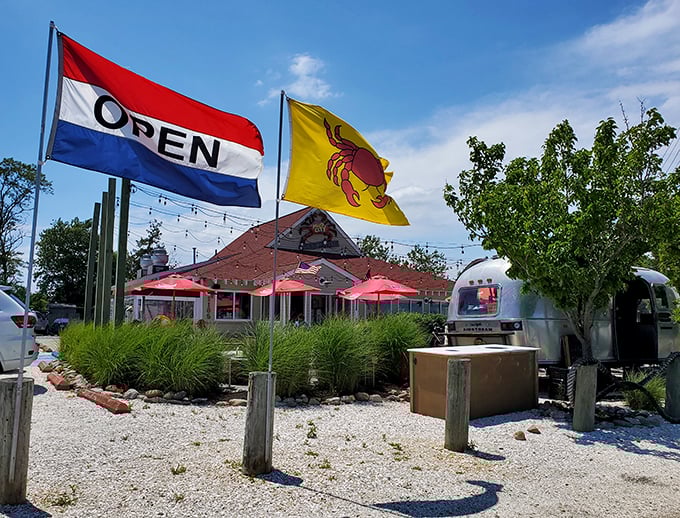 Those waving flags aren't just decoration—they're a siren call to seafood lovers everywhere. The classic "OPEN" paired with that cheerful crab says everything you need to know about the treasures waiting inside.
