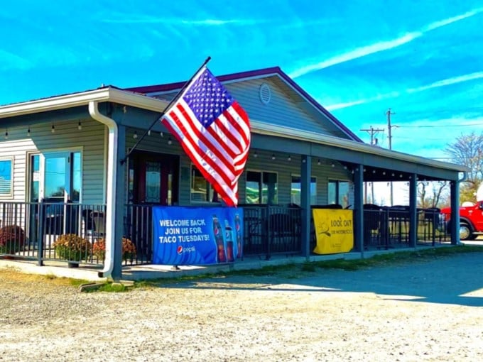 The American flag waves proudly outside 73 Grill, a humble roadside beacon promising delicious comfort in Wilmington. Taco Tuesday sign optional, satisfaction guaranteed.