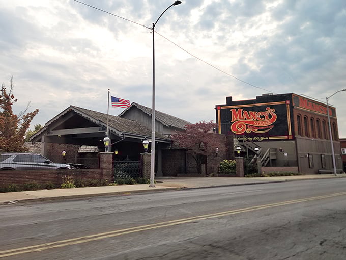 The brick exterior whispers "classic American steakhouse" while that glowing sign practically shouts "your dinner plans just got better!"