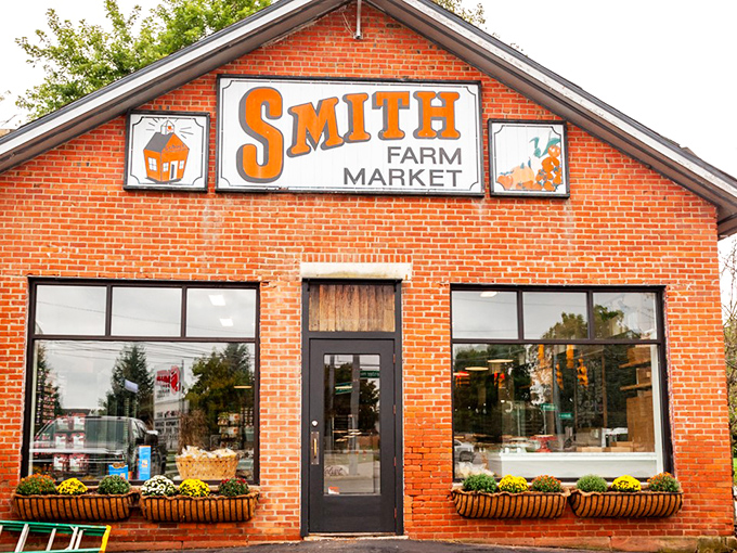 That orange sign might as well say "Happiness Ahead" – Smith Farm Market's brick façade offers a warm welcome to food lovers seeking authentic flavors.