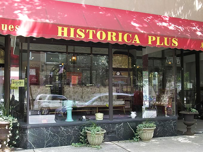 The iconic red awning of Historica Plus beckons like a portal to the past, promising treasures beyond the glass.