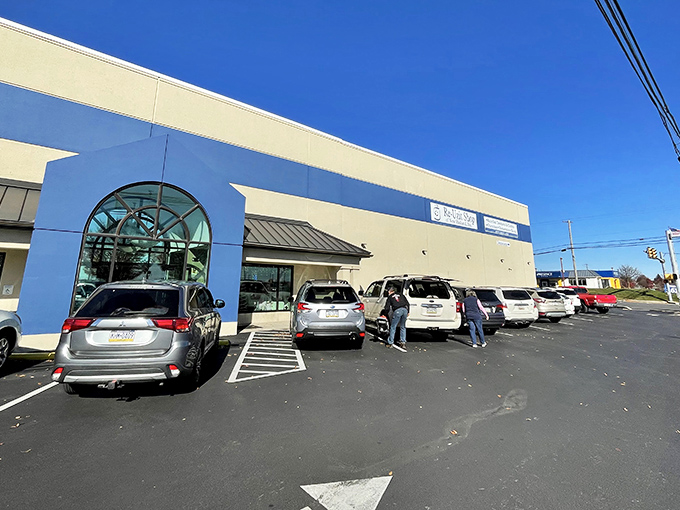 The blue and beige exterior of Re-Uzit Shop beckons like a siren call to bargain hunters, with its welcoming arched entrance promising treasures within.