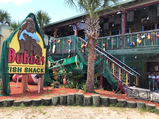 That iconic manatee mascot clutching a fish tells you everything – this isn't fancy dining, it's seafood paradise wrapped in weathered wood and coastal charm.