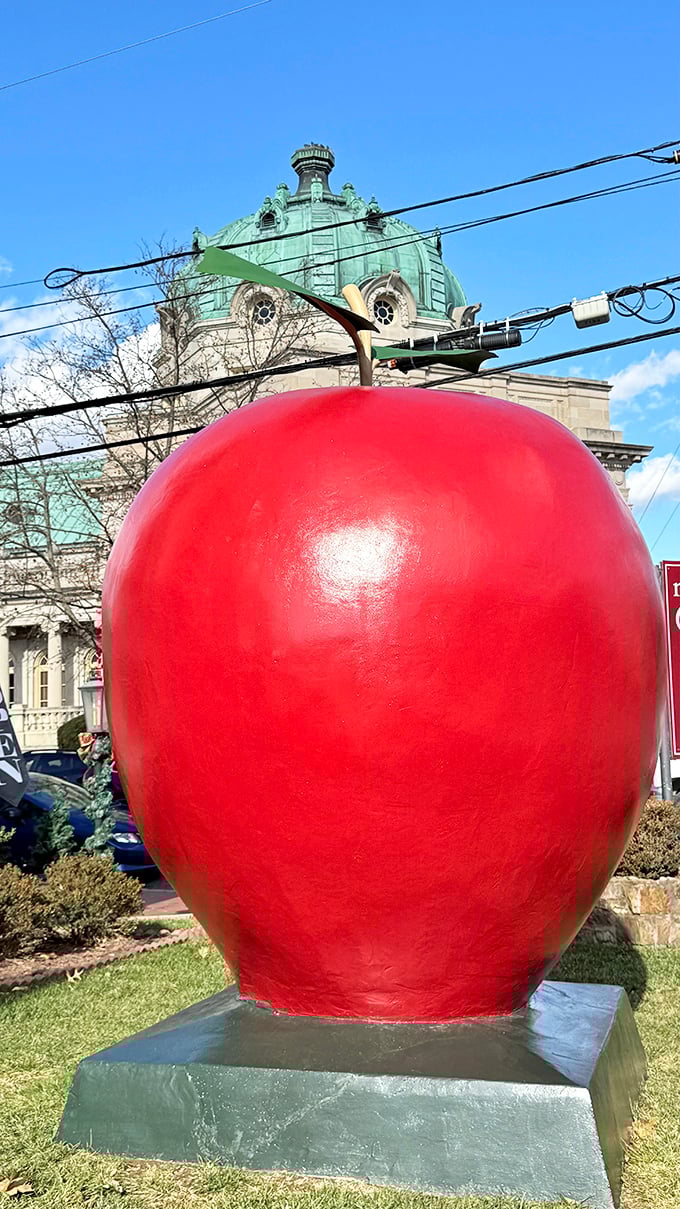The crimson giant stands proudly against Winchester's historic skyline, like a fruit that escaped from a giant's picnic basket.