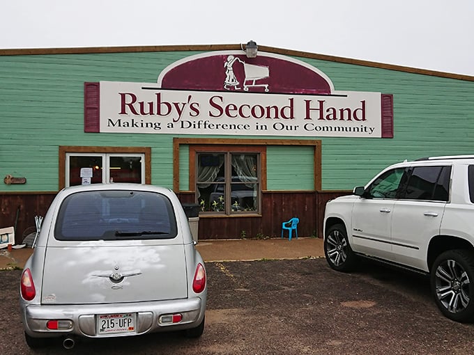 The mint-green facade of Ruby's Second Hand stands like a beacon for bargain hunters, its burgundy sign promising treasures within.