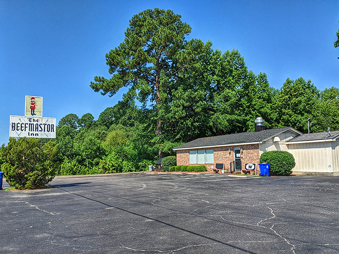 The humble exterior says it all — this place isn’t about fancy facades. The real magic happens behind that brick wall and classic roadside sign.