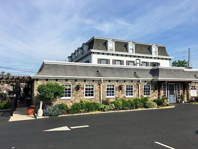 The historic fieldstone façade of Spring House Tavern stands proudly against a blue Pennsylvania sky, its centuries-old charm immediately transporting visitors to another era.