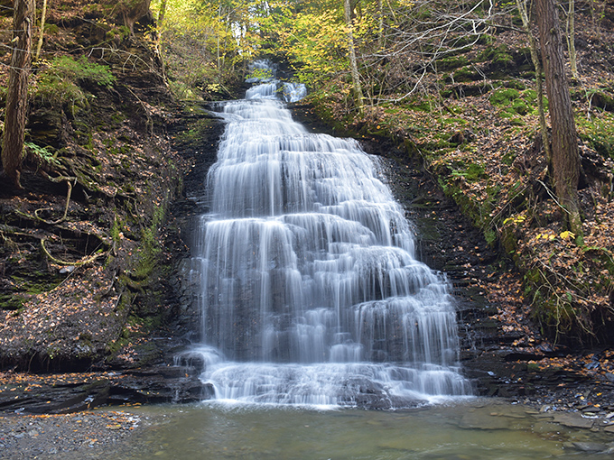 Cascading like nature's own staircase, this waterfall transforms in autumn when surrounded by a kaleidoscope of fall foliage – Mother Nature showing off her best work.