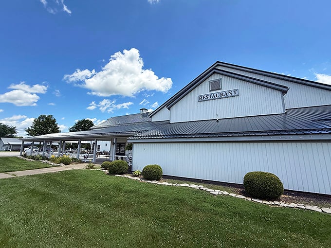 The classic white barn exterior of Gasthof stands proudly against an Indiana sky, promising comfort food that'll make your cardiologist wince and your soul rejoice.