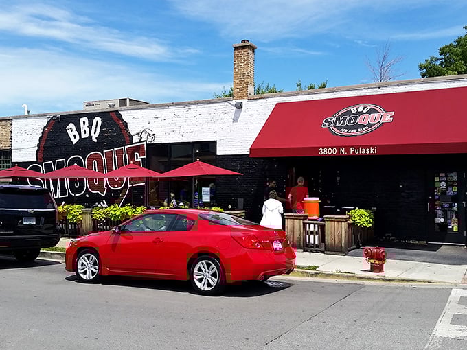 The iconic red and black exterior of Smoque BBQ stands like a beacon for barbecue pilgrims. That "Low and Slow" motto isn't just clever marketing—it's a solemn promise.