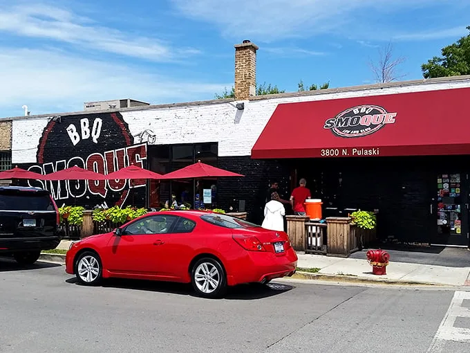 The iconic red and black exterior of Smoque BBQ stands like a beacon for barbecue pilgrims. That "Low and Slow" motto isn't just clever marketing—it's a solemn promise.
