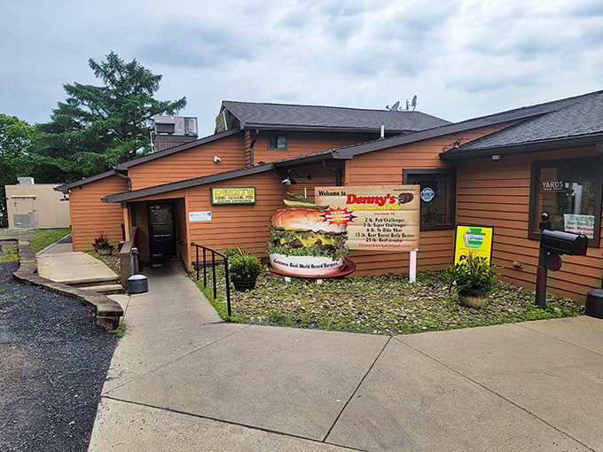 The unassuming exterior of Denny's Beer Barrel Pub hides a burger paradise within. Like finding a treasure chest disguised as a garden shed.