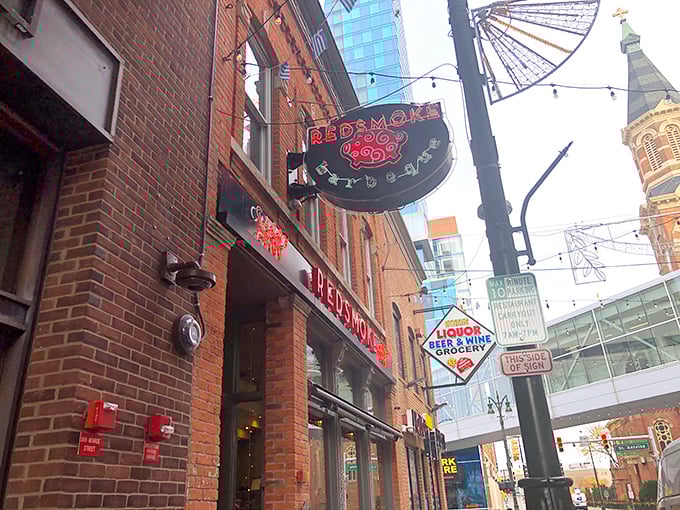 Detroit's skyline peeks through as Redsmoke's vintage-modern exterior beckons hungry visitors with its unmistakable pig logo – a sign that serious BBQ awaits inside.