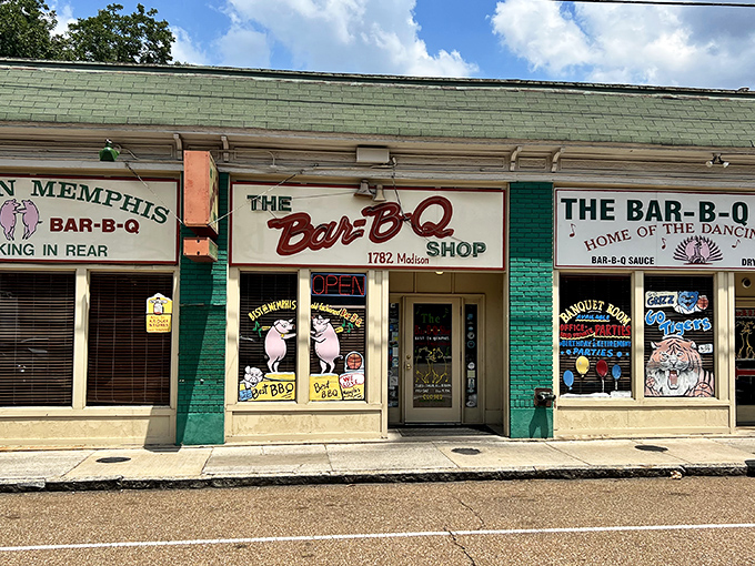 The mint-green storefront with its dancing pig mascots isn't trying to impress anyone—it doesn't need to. The food does all the talking.