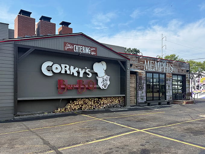 The barbecue beacon of Memphis stands proud with its iconic pig chef logo and stacked woodpile—a smoky promise of deliciousness awaits inside.
