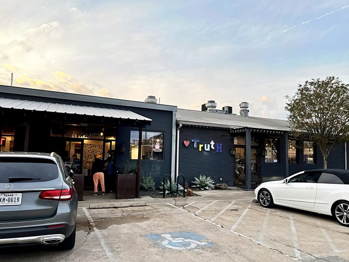 Truth's navy blue exterior with its colorful lettering doesn't scream "barbecue royalty," but that's Texas for you—the best spots often hide in plain sight.