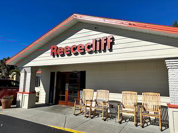 The welcoming facade of Reececliff Family Diner beckons with its classic red trim and row of rocking chairs – Florida's version of a front porch welcome committee.